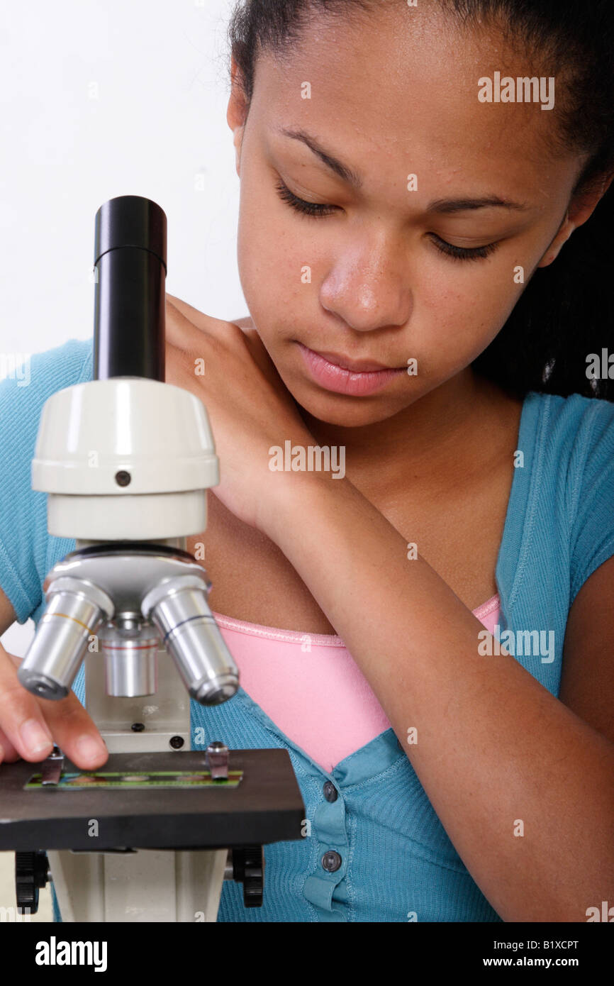 Stock Photograph of a student adjusting a slide on a microscope Stock ...