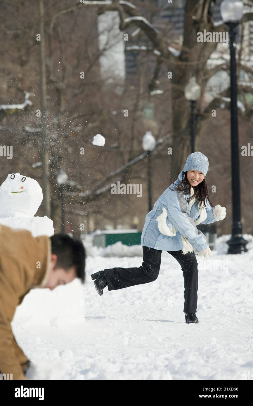 Young couple playing snowball fight Stock Photo - Alamy