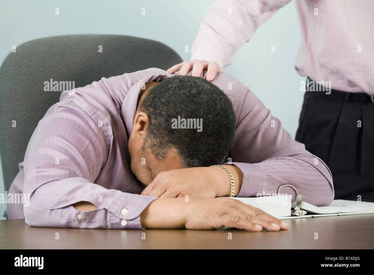 Mid section view of a businessman consoling his colleague Stock Photo ...