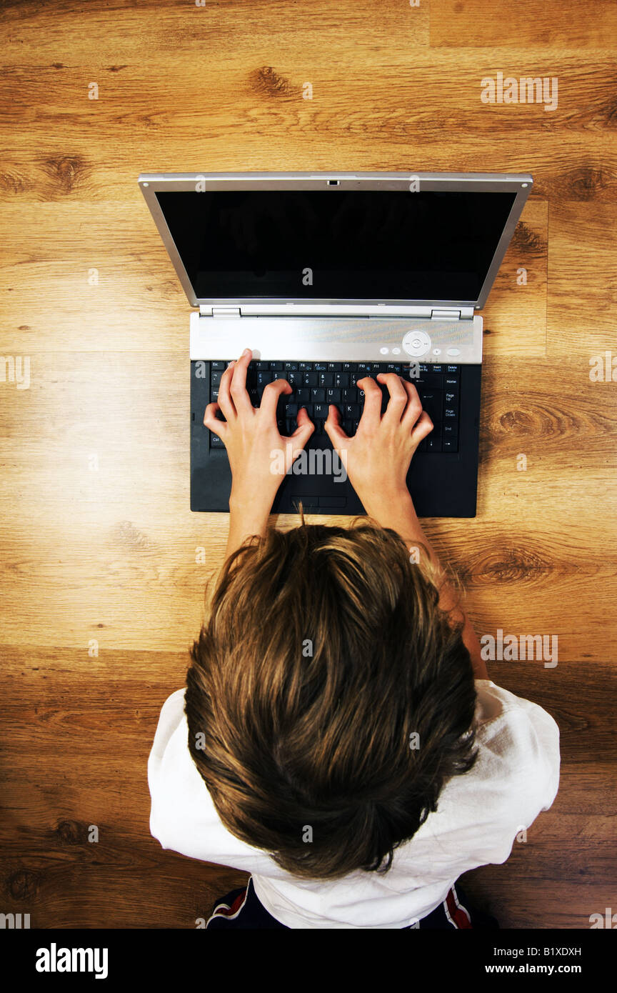 Young boy / pupil doing homework / online on laptop Stock Photo - Alamy