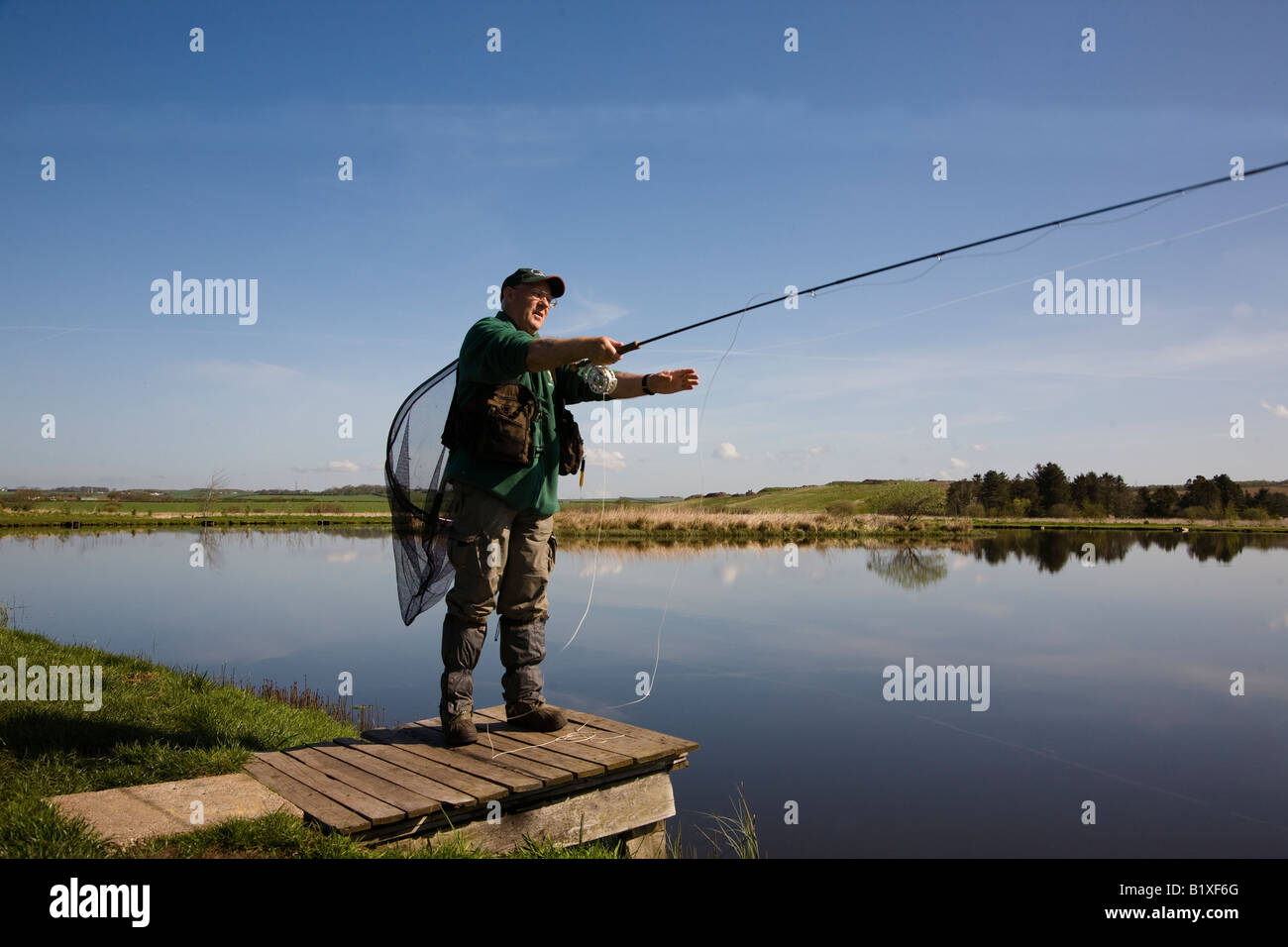 man fishing for trout using rod and line Stock Photo - Alamy