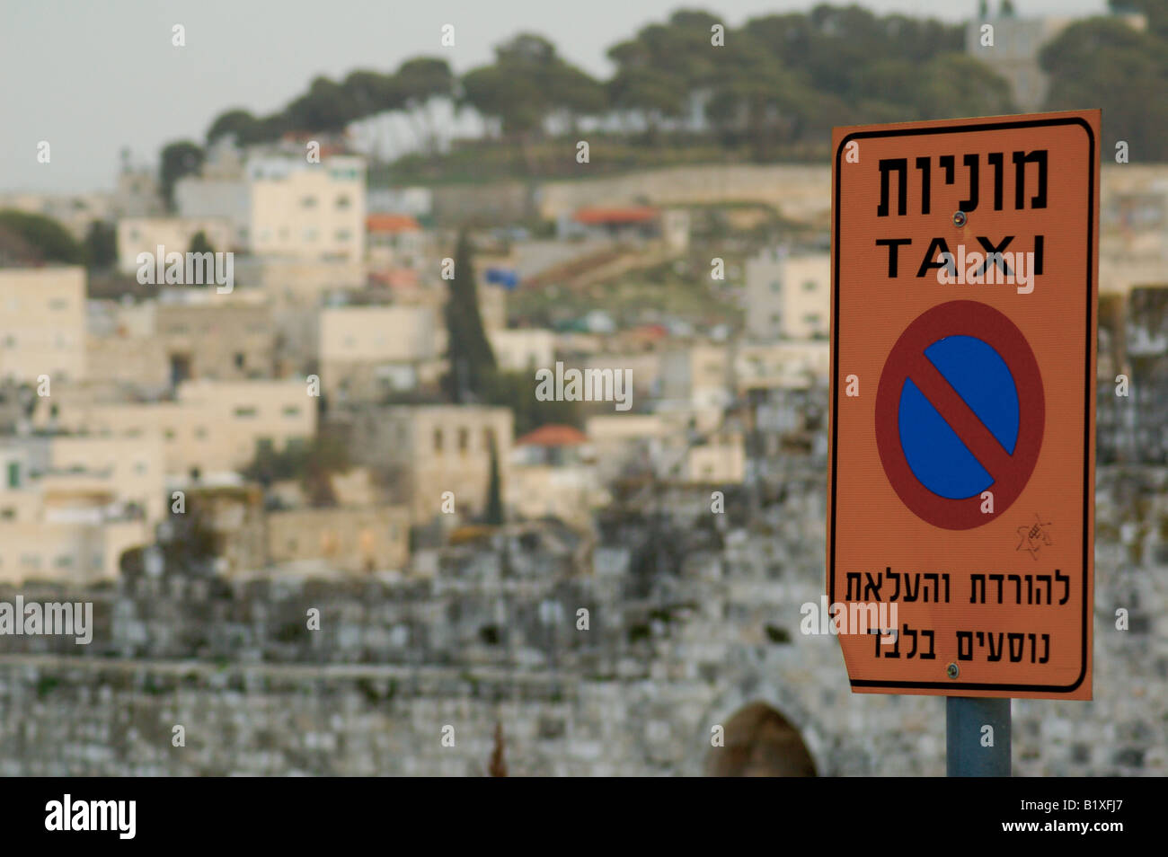 A Hebrew taxi sign stands outside of Jerusalem's Old City, with the ...