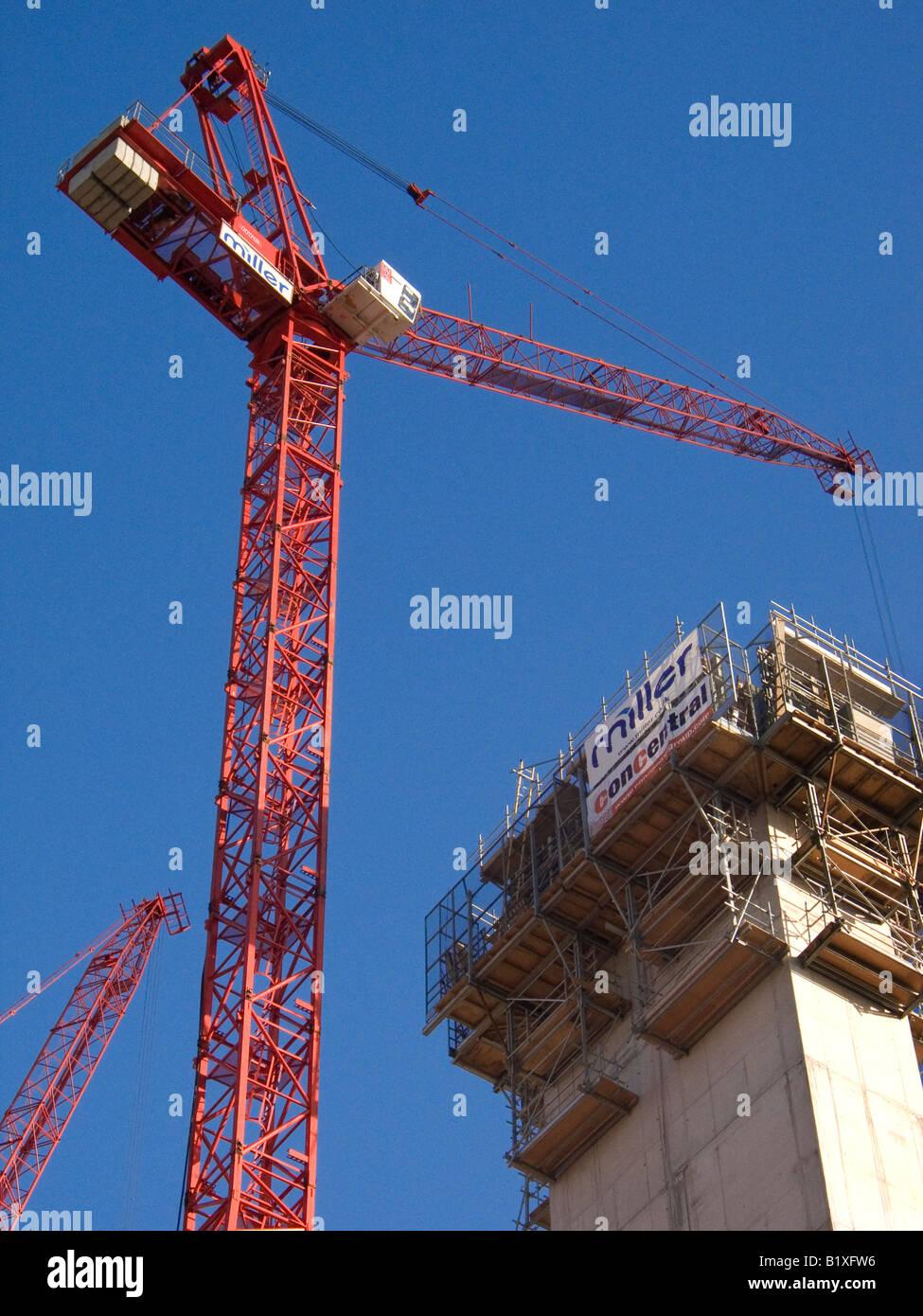 buildings under construction with red tower crane blue sky Stock Photo ...