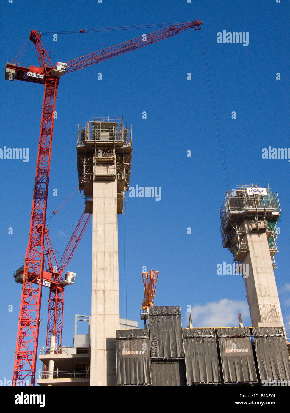buildings under construction with red tower crane blue sky Stock Photo ...