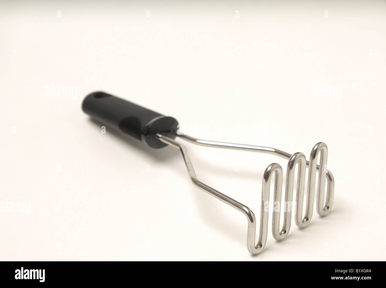 potato mashing tool for the kitchen Stock Photo - Alamy
