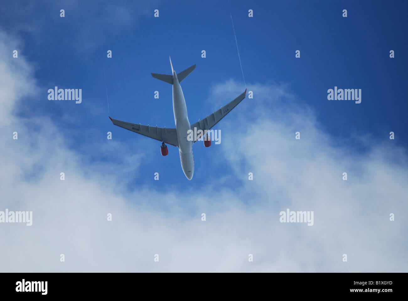 Airplane while flying bottom view with sky in background Stock Photo ...