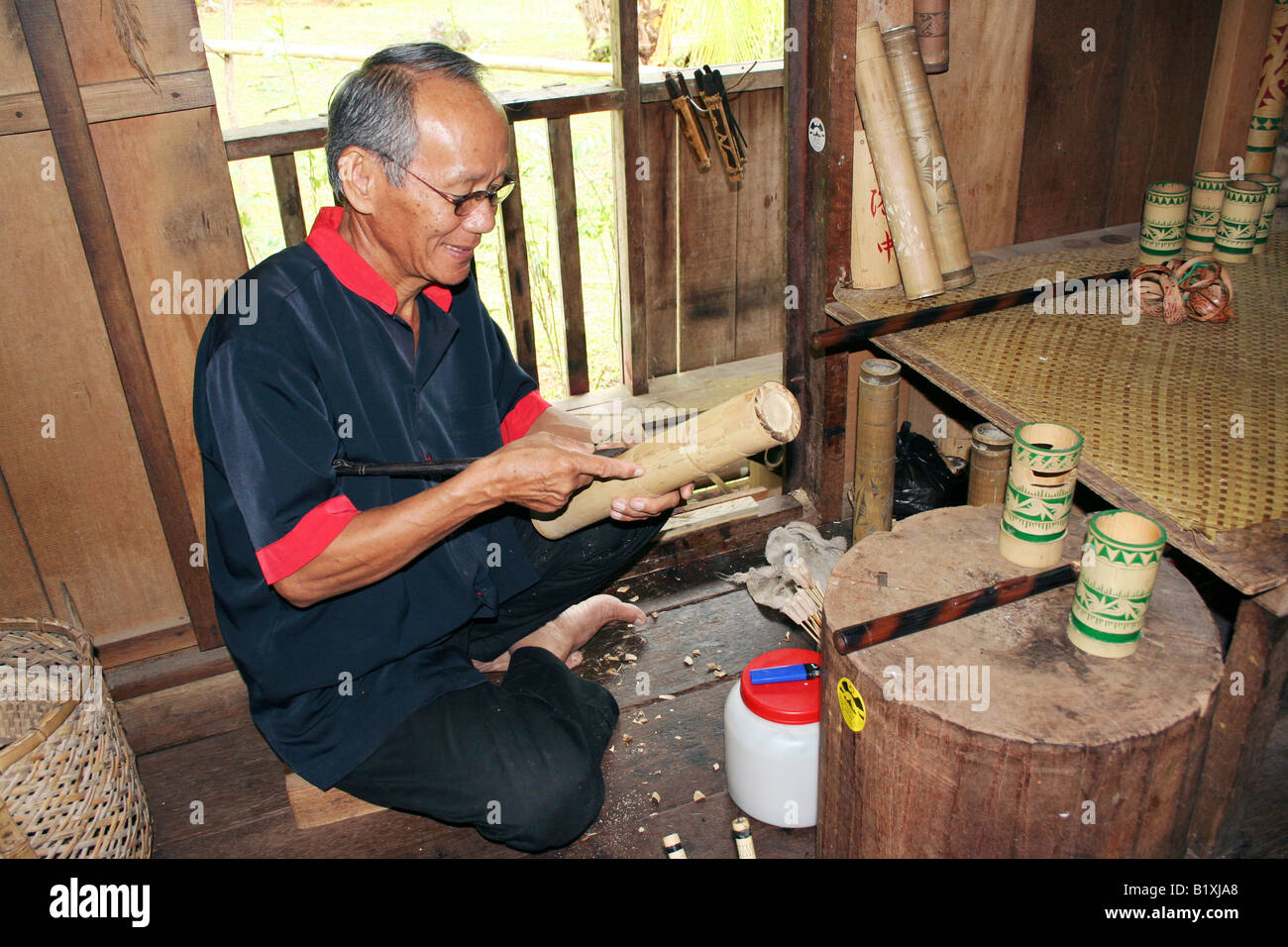 A native of Sarawak in Malaysia making souvenir for tourist Stock Photo ...