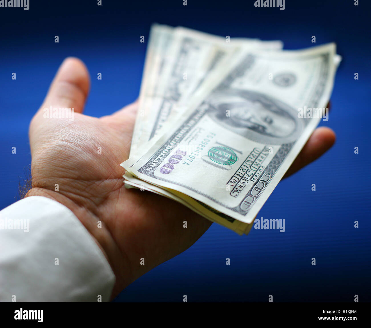 Dollars are in a hand Stock Photo - Alamy