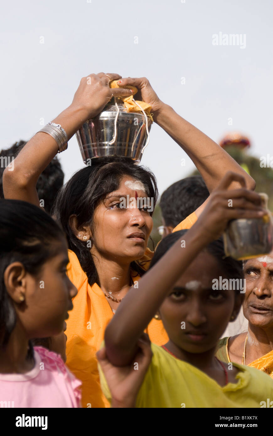 DEVOTEE CARRYING POT OF MILK OFFERING AT THE ANNUAL HINDU FESTIVAL OF ...