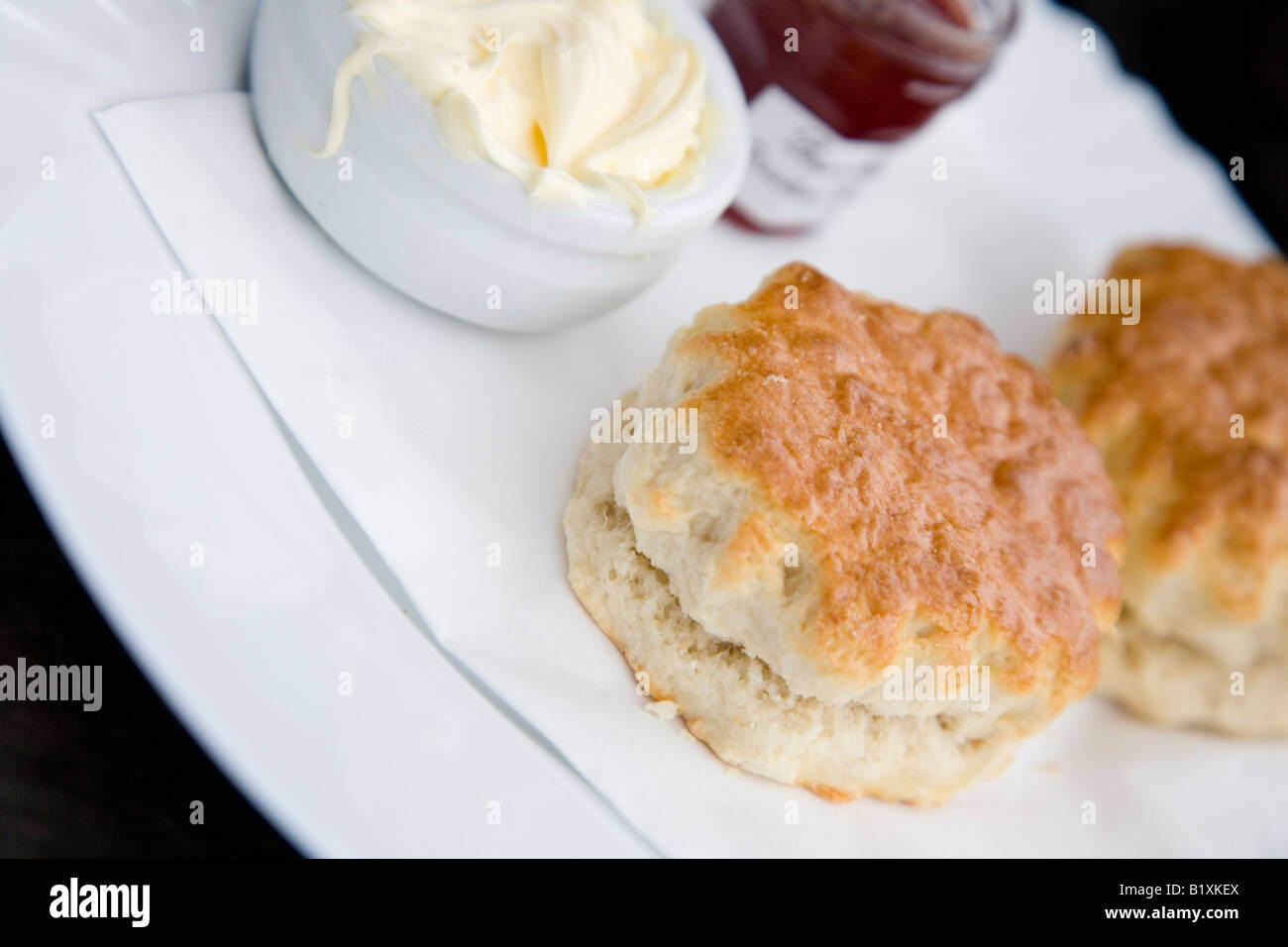 A traditional English Cream Tea comprising tea scones jam and cream ...