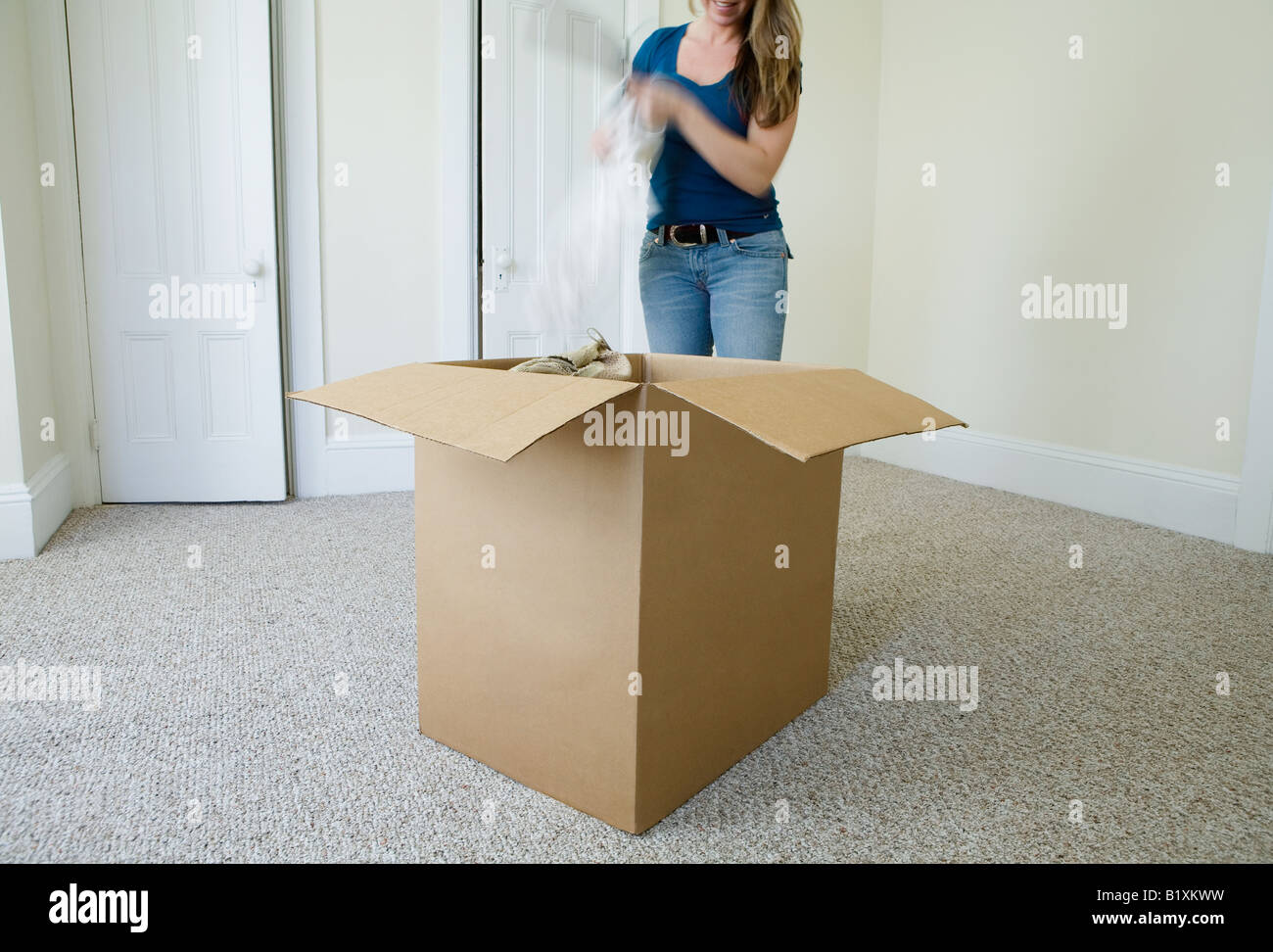 Woman unpacking box Stock Photo - Alamy
