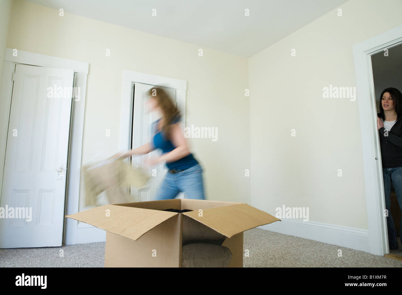 Women in empty room of a house Stock Photo - Alamy