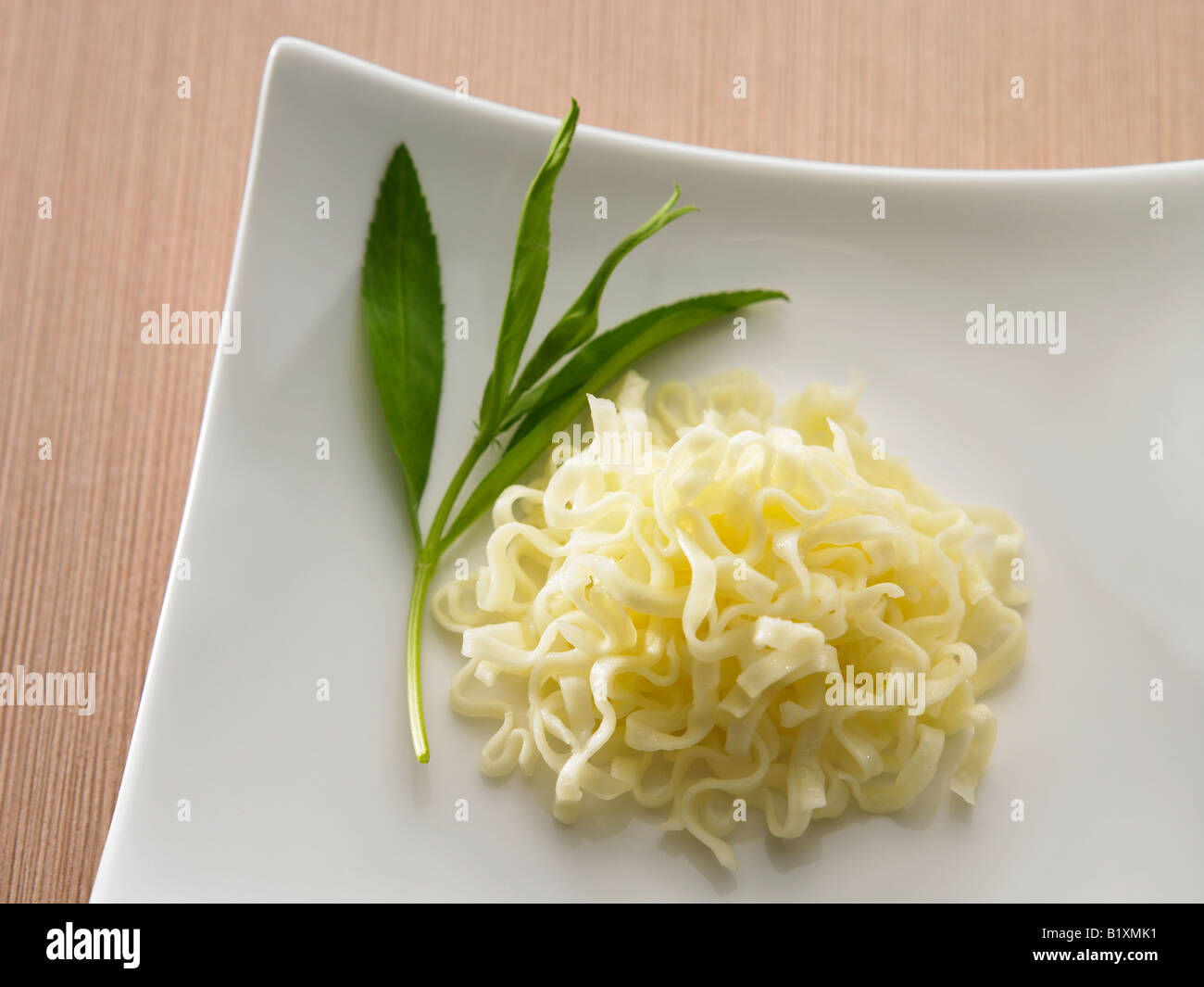 a plate of noodle with sage leaves Stock Photo - Alamy