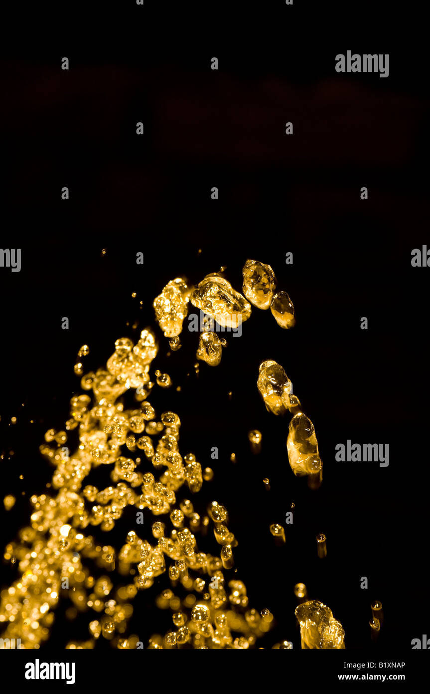 Golden nuggets of water spraying forth among the droplets Stock Photo ...