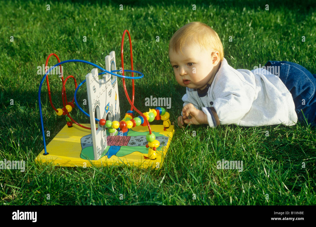 baby boy exploring a toy Stock Photo - Alamy