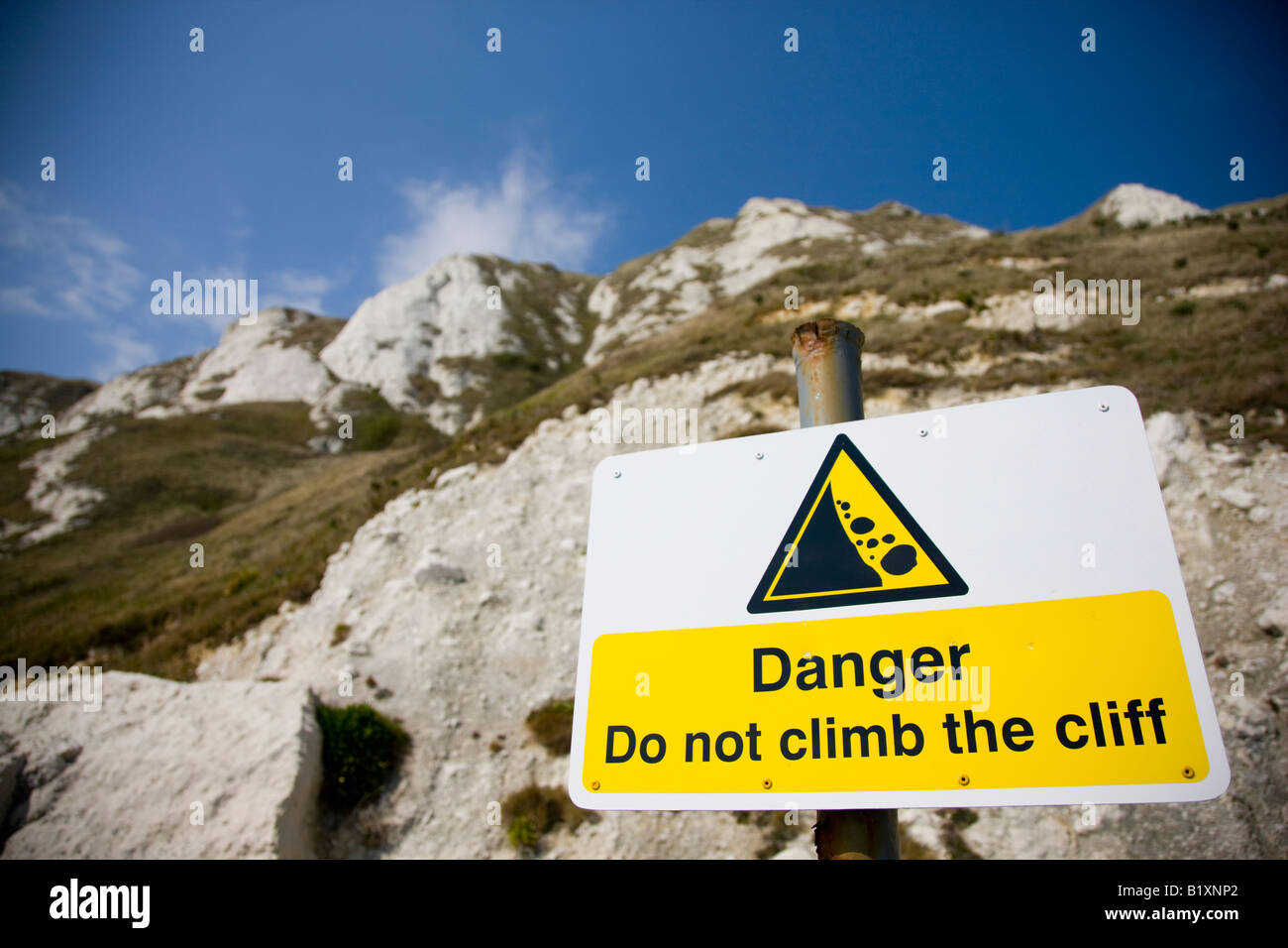 Sign stating Danger Do not climb this cliff Stock Photo - Alamy