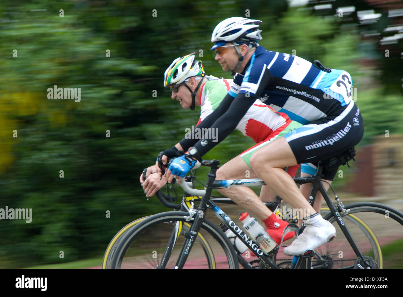 Two cyclists competing in a bicycle race, Warwickshire, UK Stock Photo ...