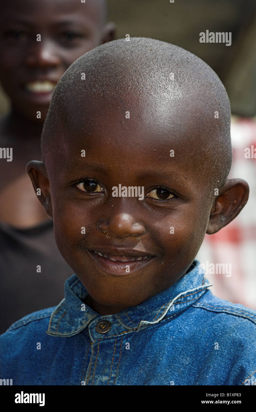 Young African boy smiling at camera with blue shirt on western Kenya ...