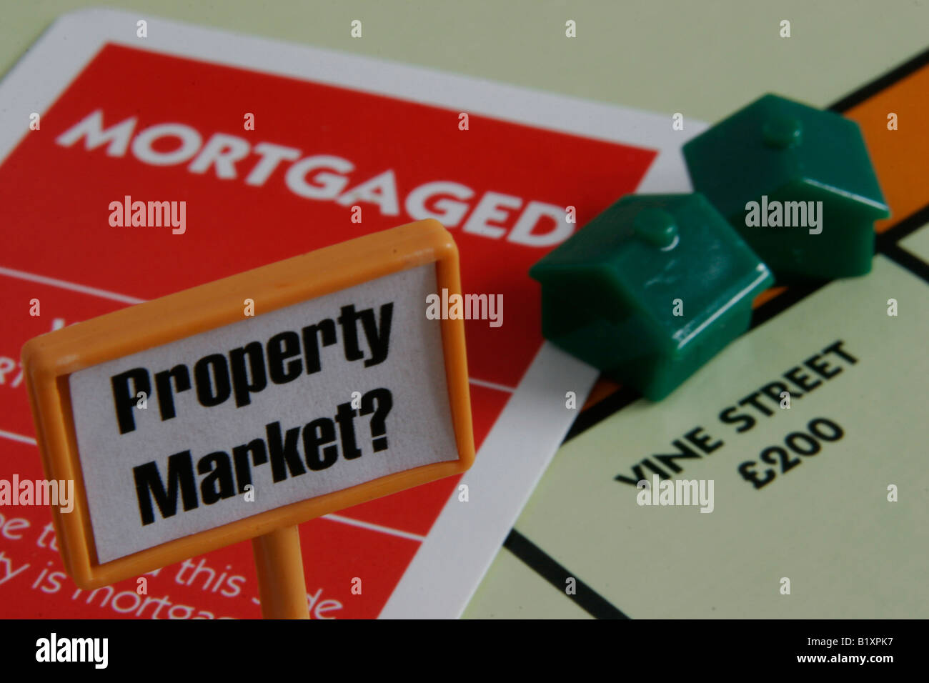 Monopoly board and houses with 'property market?' sign Stock Photo - Alamy