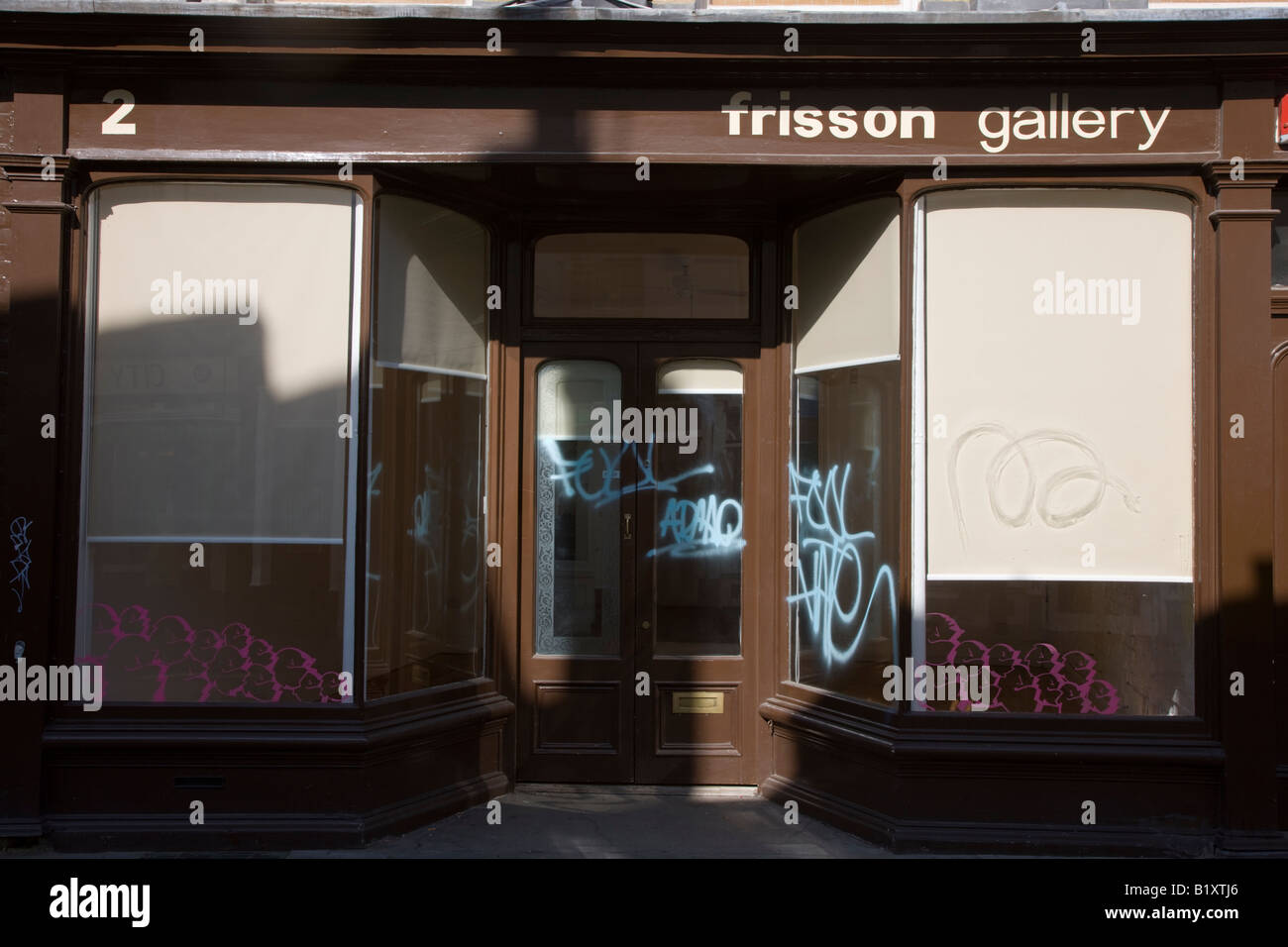 Empty gallery and art shop window attacked by graffiti street artists ...