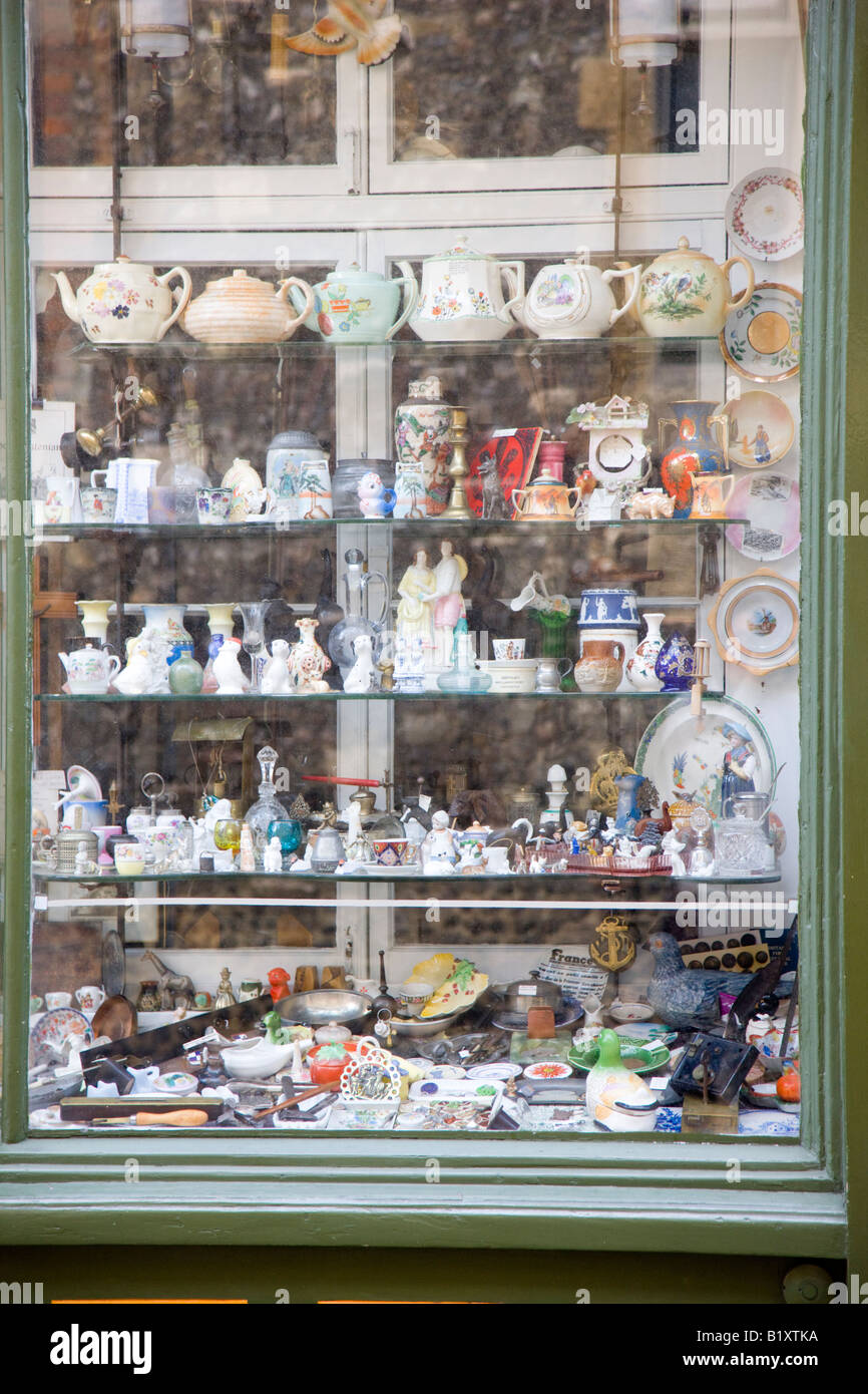 Antiques shop window with bottles and small china ornaments Stock Photo ...