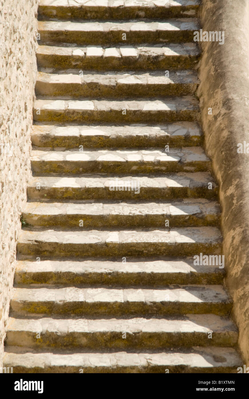 Vertical close up of a flight of old stone steps in the sunshine Stock ...