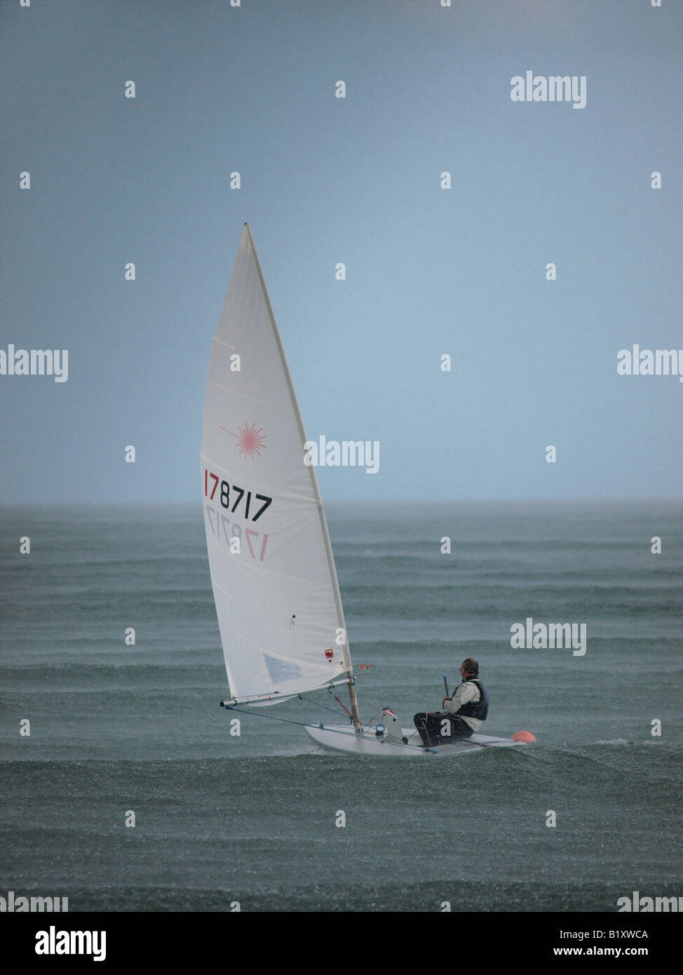 Sailing dinghy in rain Stock Photo - Alamy