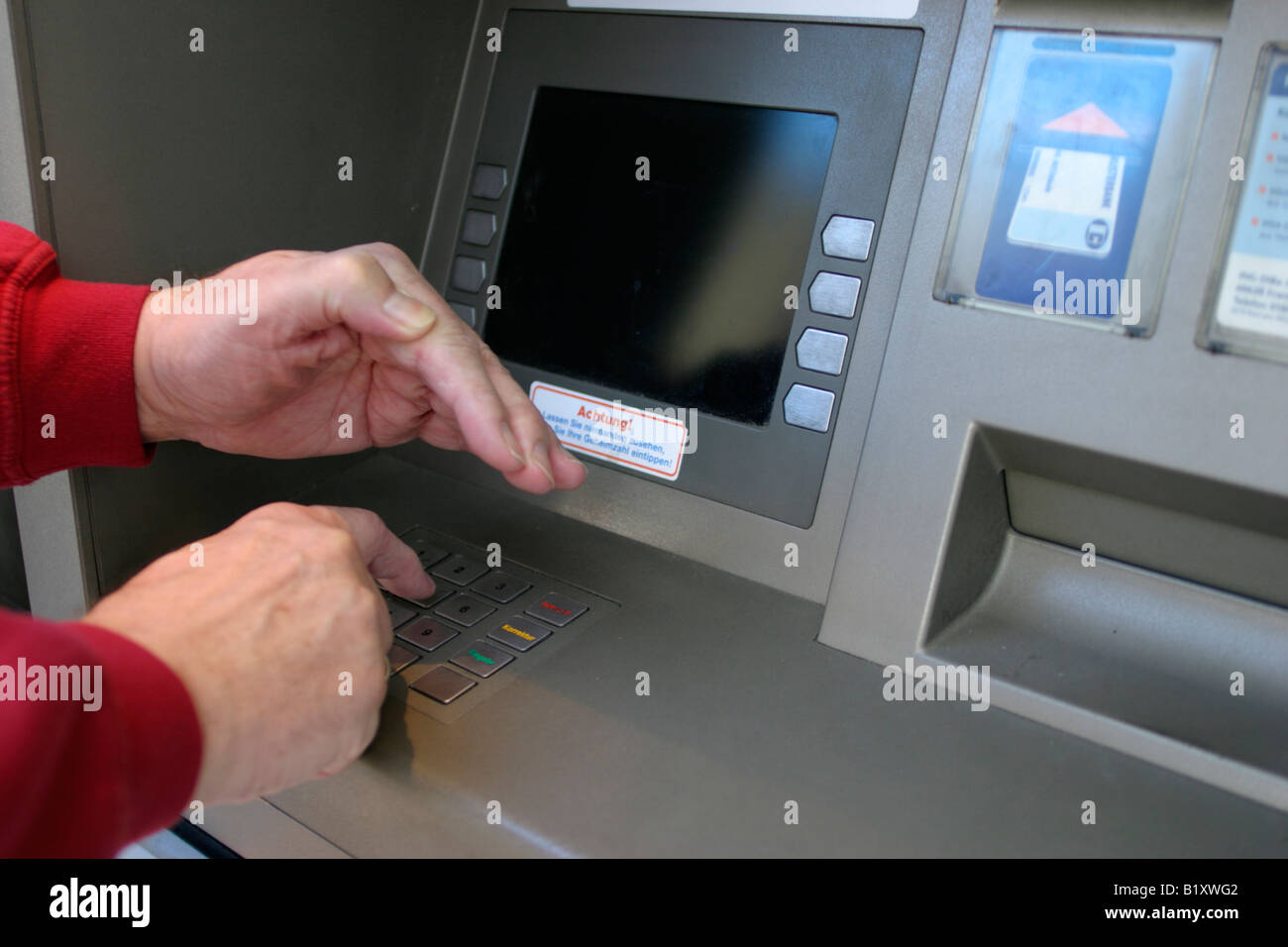 a man withdrawing money at a cash machine Stock Photo - Alamy