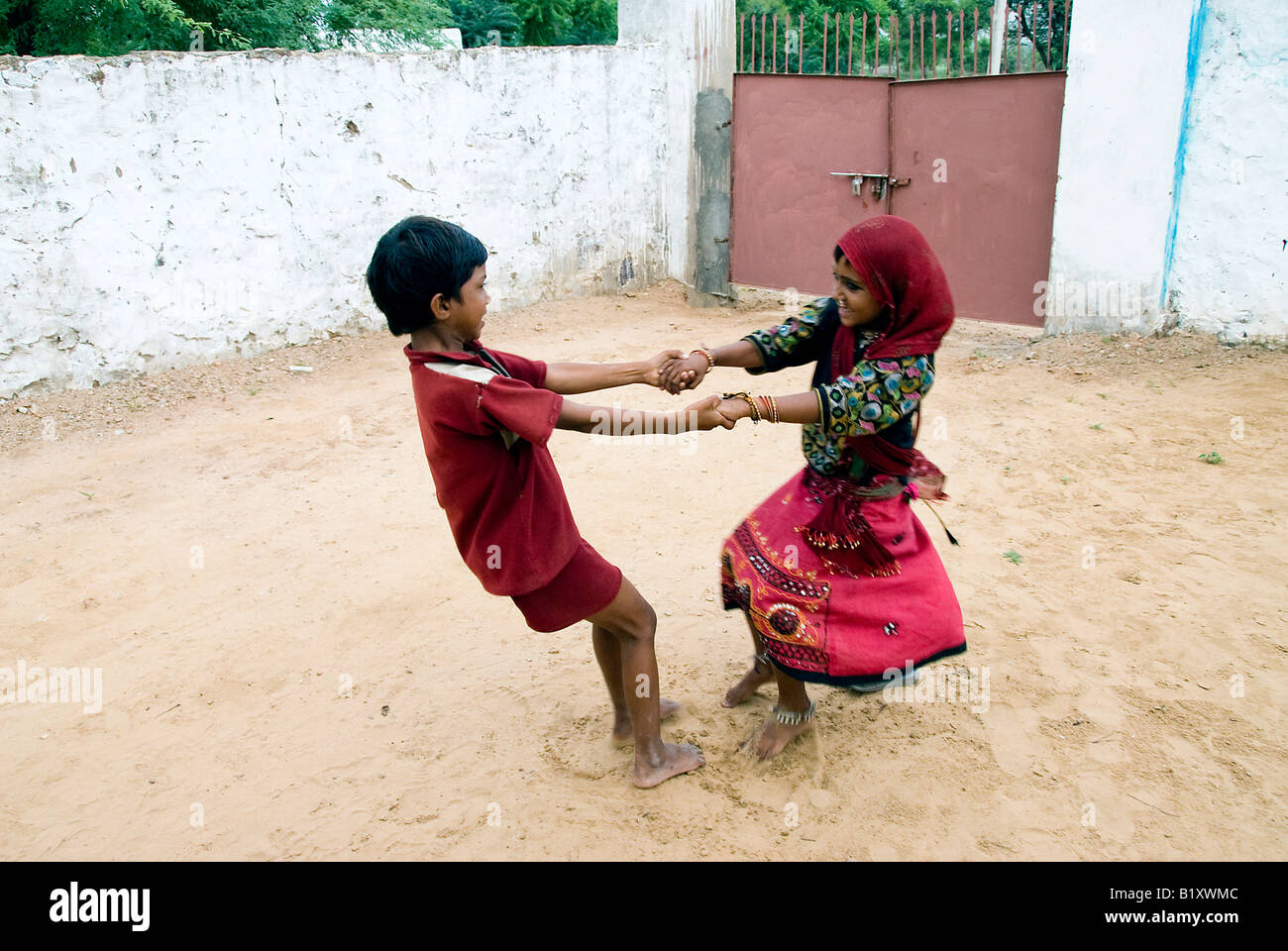 Happy Rajasthani children playing in a courtyard, Thar desert, India ...
