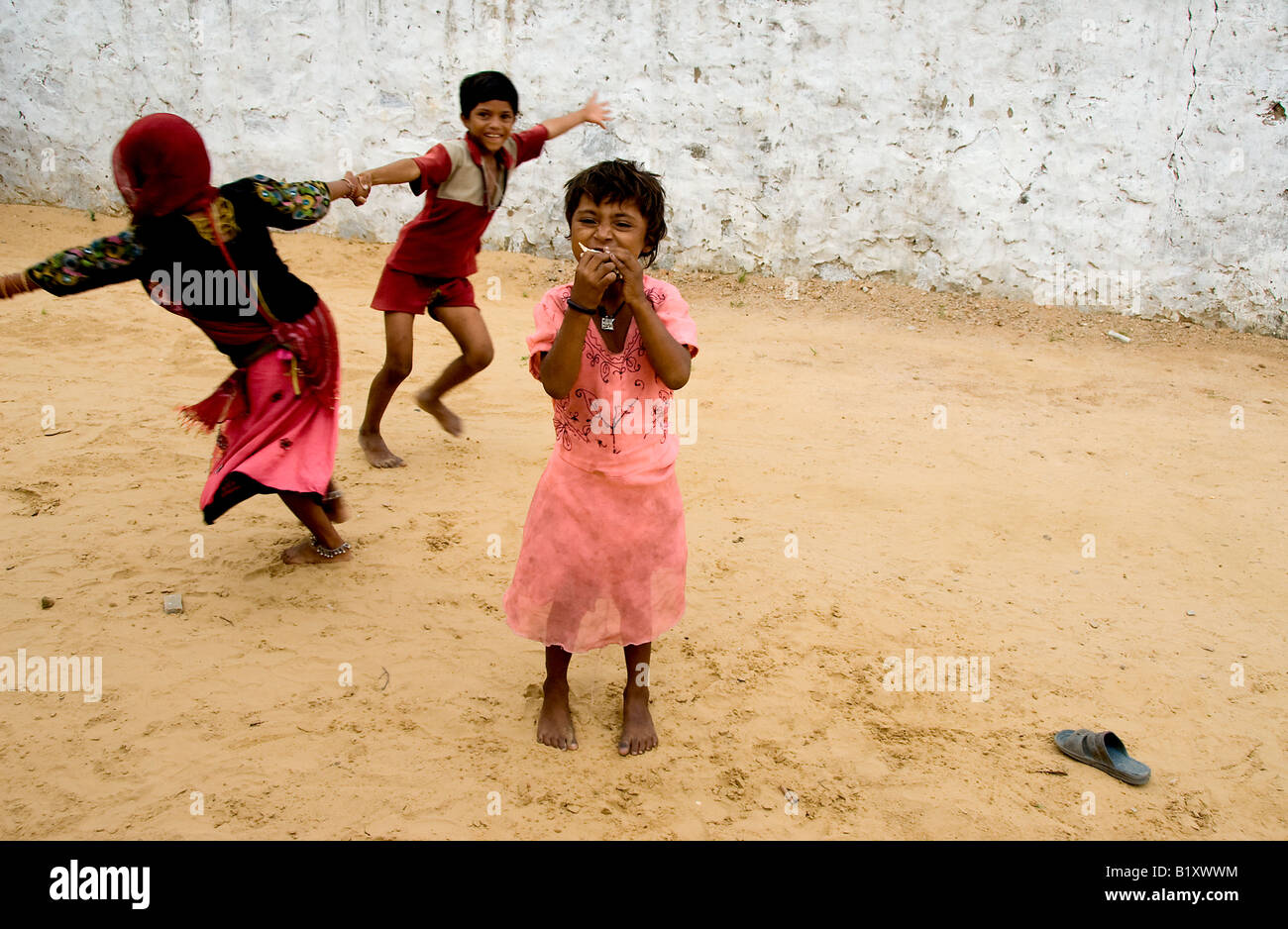 Happy Rajasthani children playing in a courtyard, Thar desert, India ...