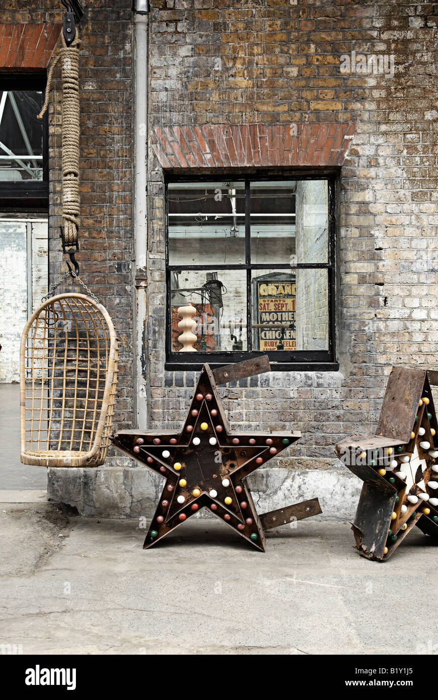Large metal fairground star in a warehouse in London with a hanging ...
