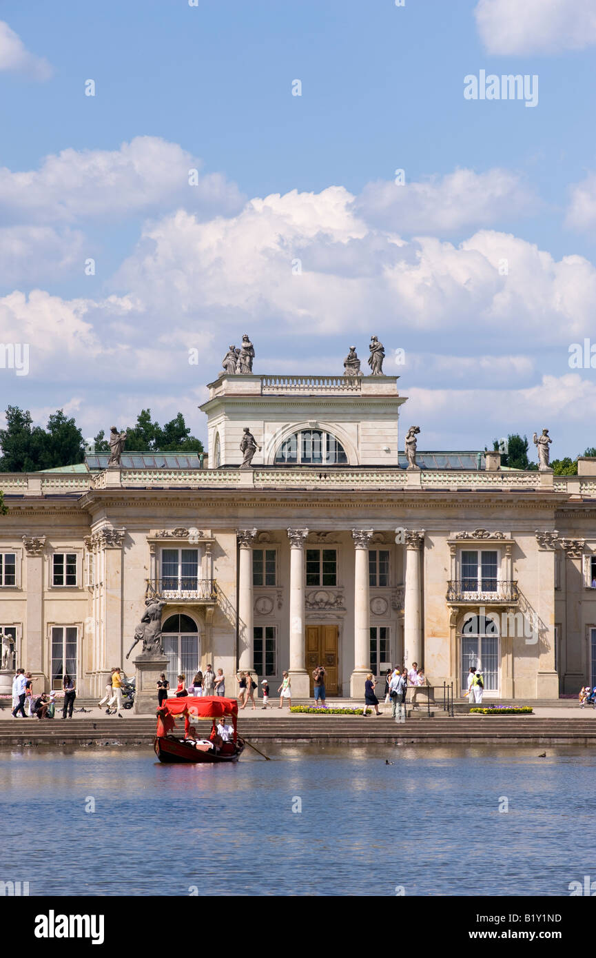 People relax in a gondola with Lazienkowski Palace in background ...
