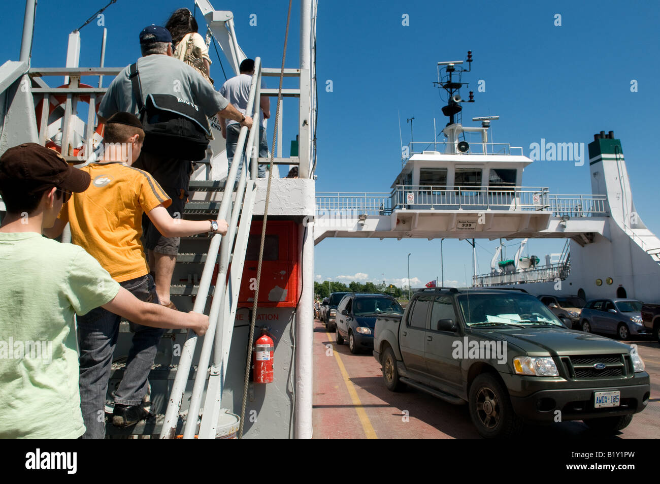 Passengers board the Wolfe Island Ferry in Kingston, Ontario, Canada ...