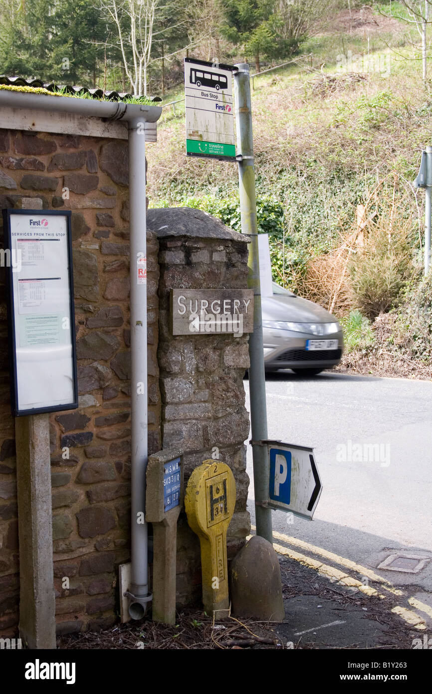 Bus Stop next to sign to Doctors Surgery in Dunster, Somerset Stock ...