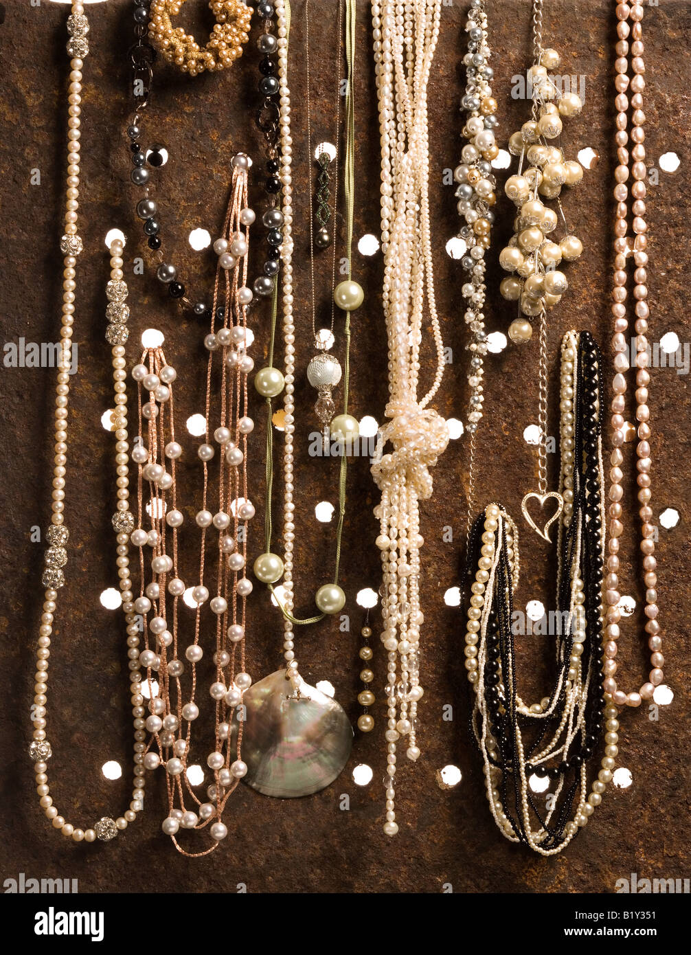 Pearl jewelry on rusty metal background Stock Photo - Alamy