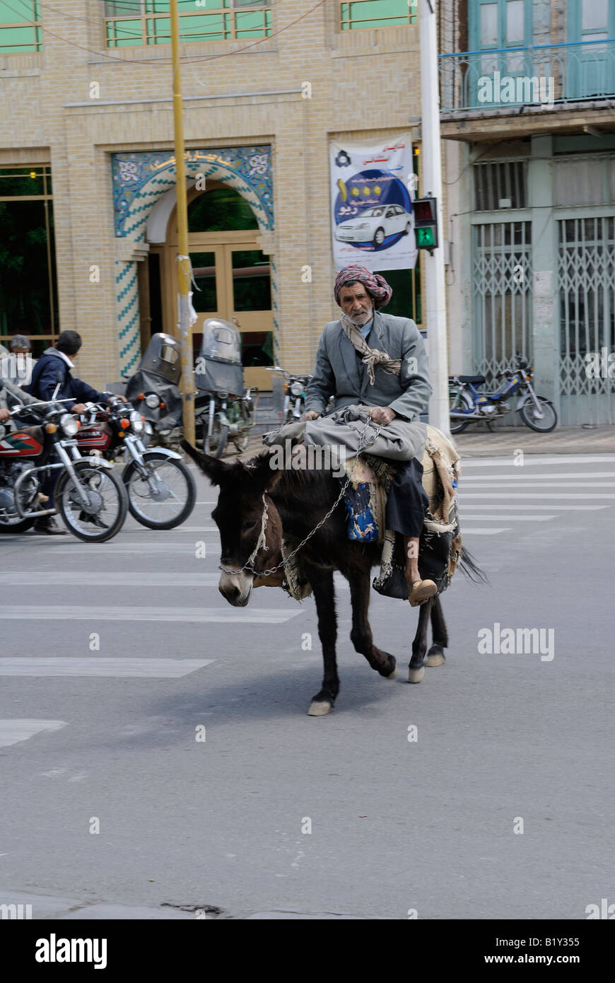 Man on mule crossing a busy intersection in Yazd, Iran Stock Photo - Alamy
