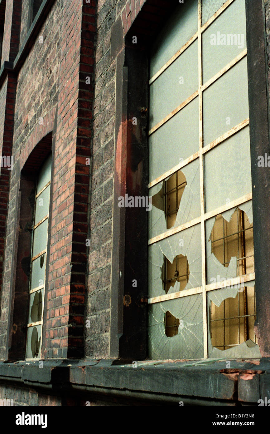 Shattered windows of an old factory building Stock Photo - Alamy