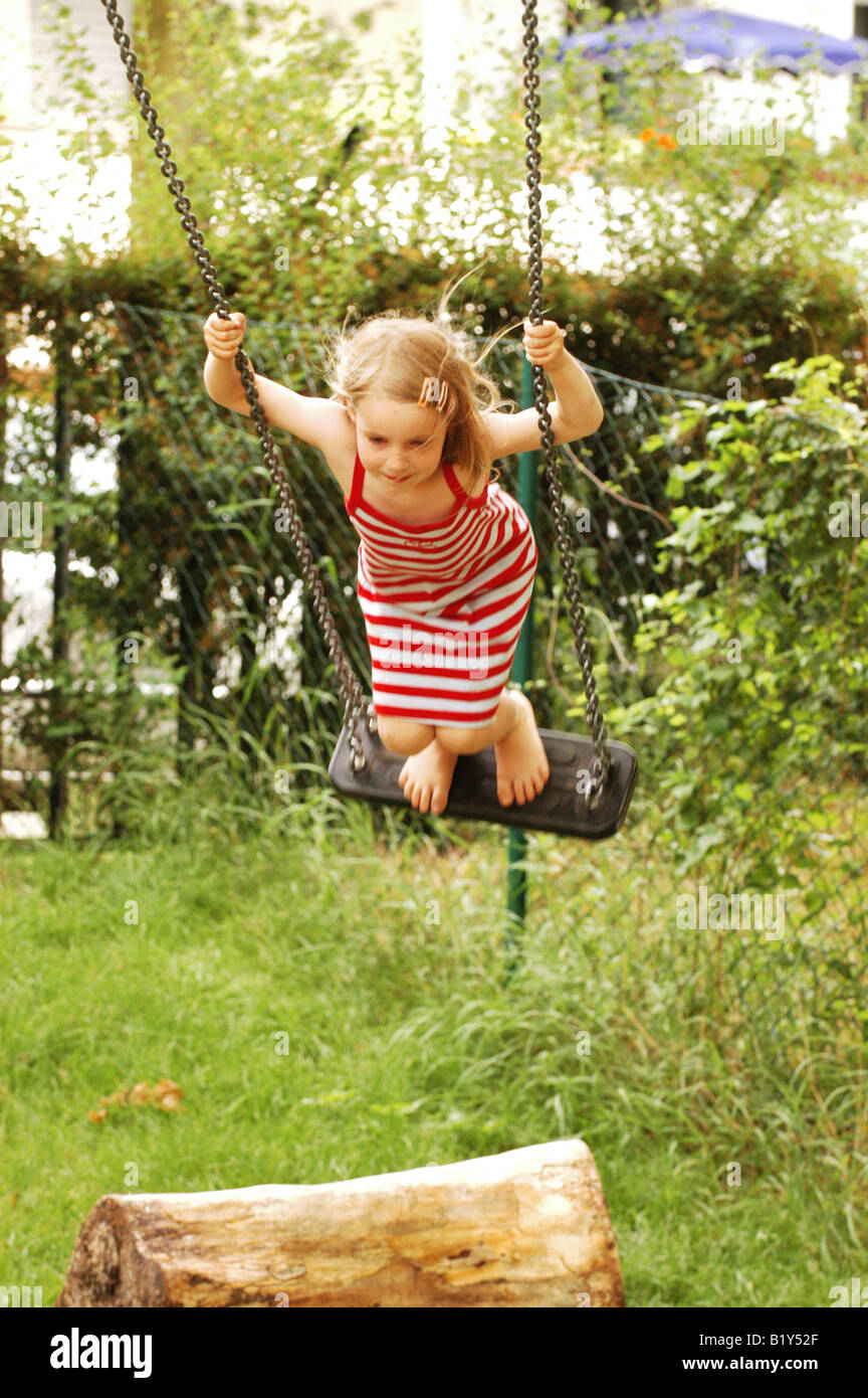 a small girl swinging,intuitive learning Stock Photo - Alamy