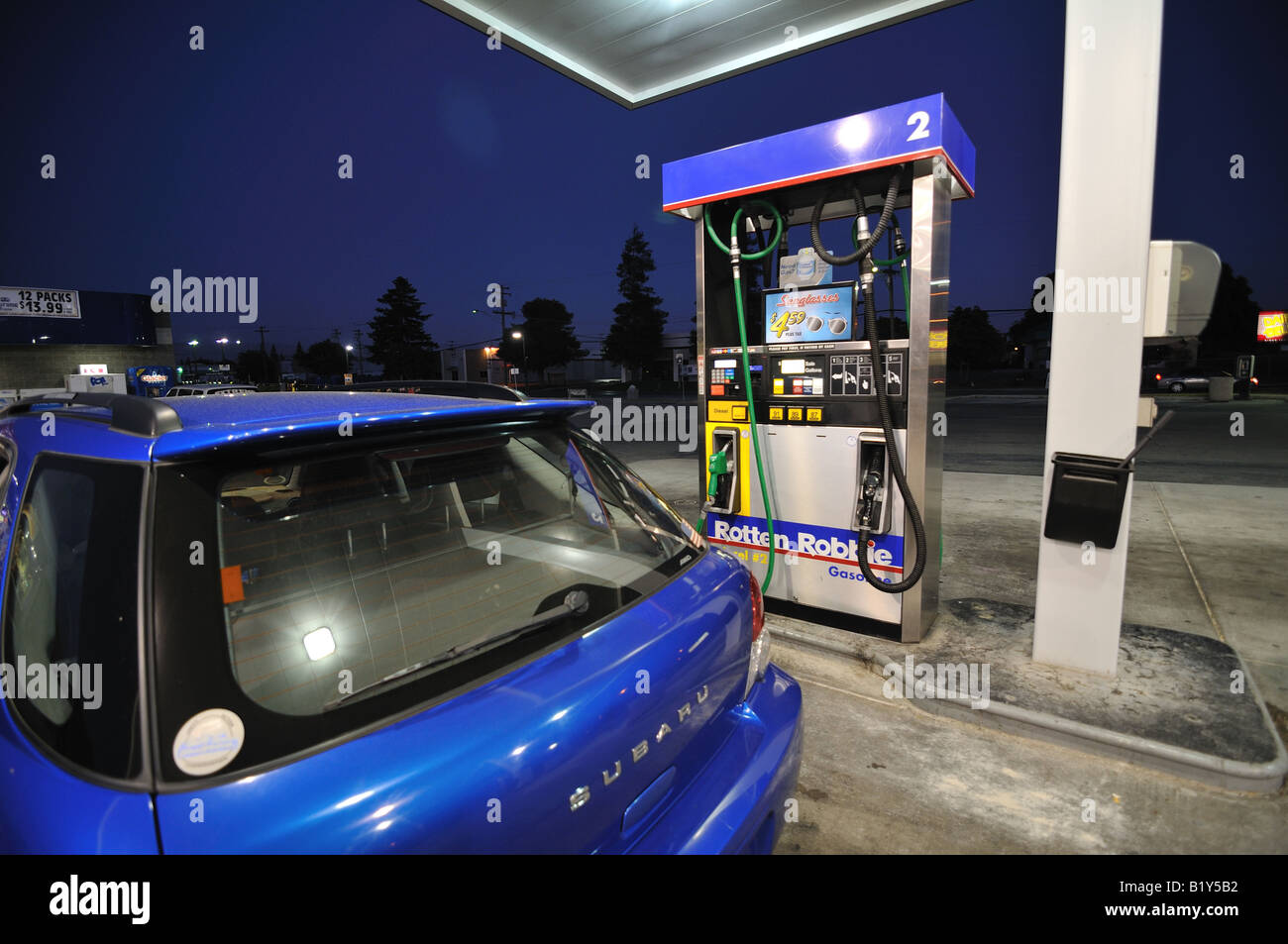 A blue Subaru station wagon sits in front of a gas pump in San Jose ...
