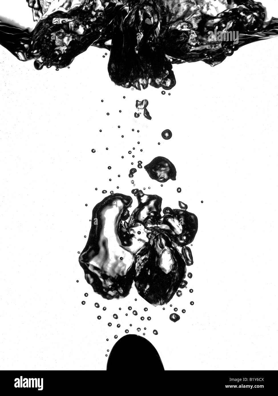 Pebble falling in water making bubbles Stock Photo - Alamy