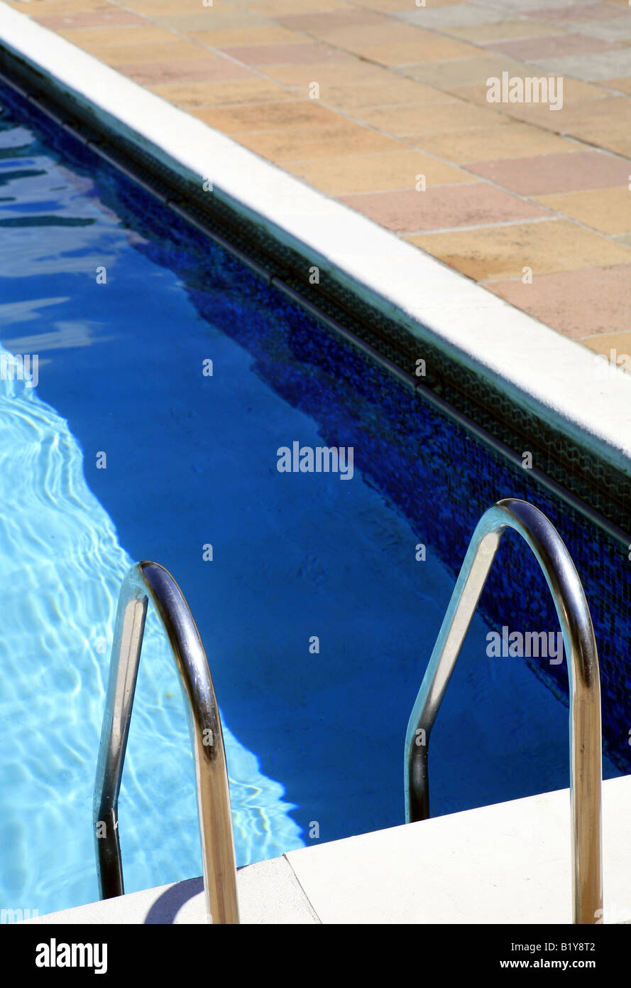 Stainless steel steps into an outdoor swimming pool Stock Photo - Alamy