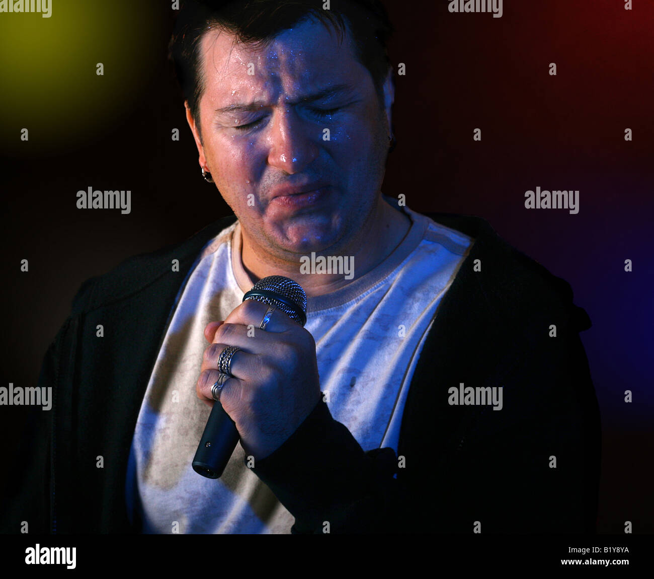 Rock singer on a scene singing rock in ecstasy Stock Photo - Alamy