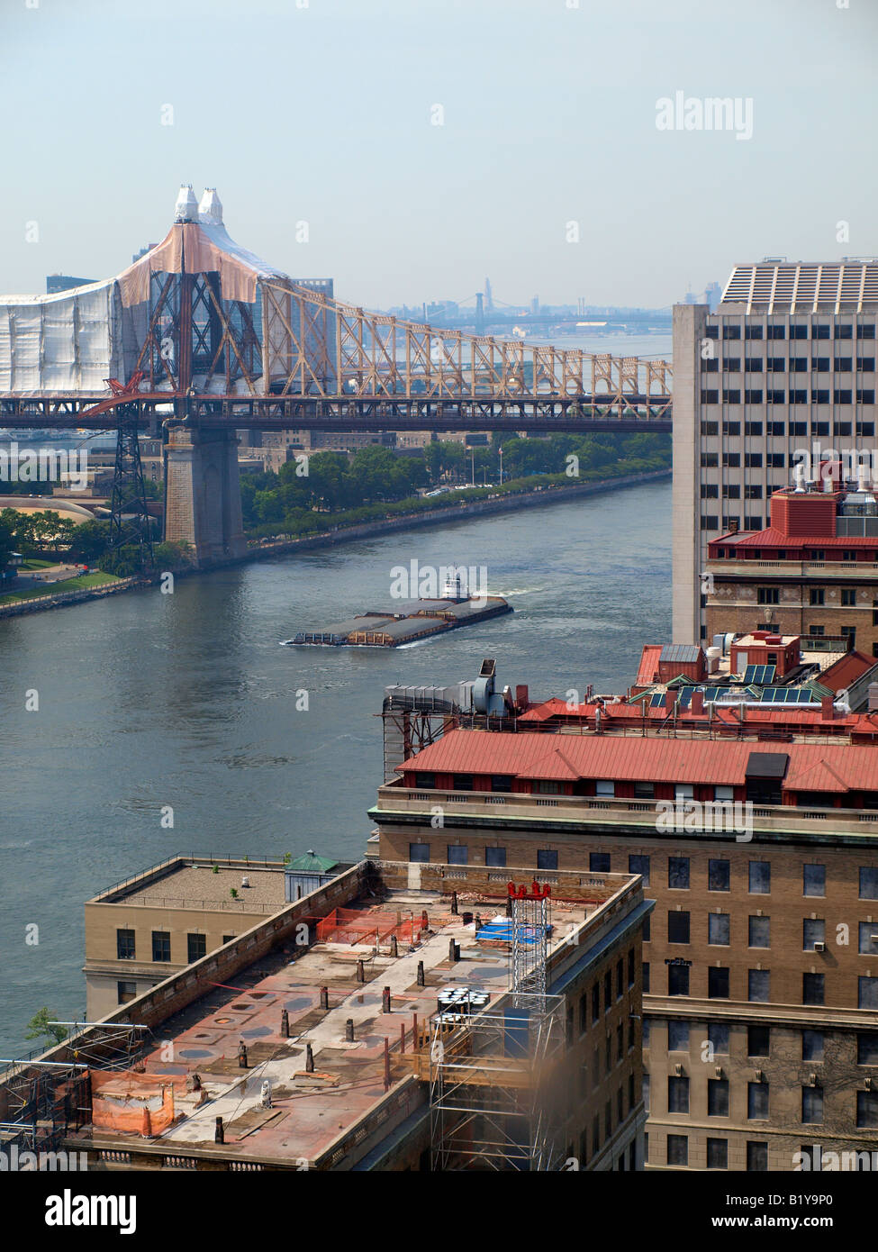 Barge floating down the East River of New York City Stock Photo - Alamy
