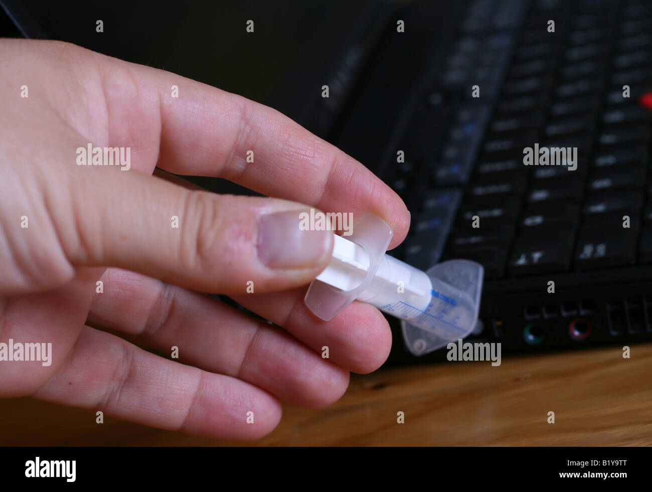 Giving a shot to a laptop in order to protect it from data virus Stock ...