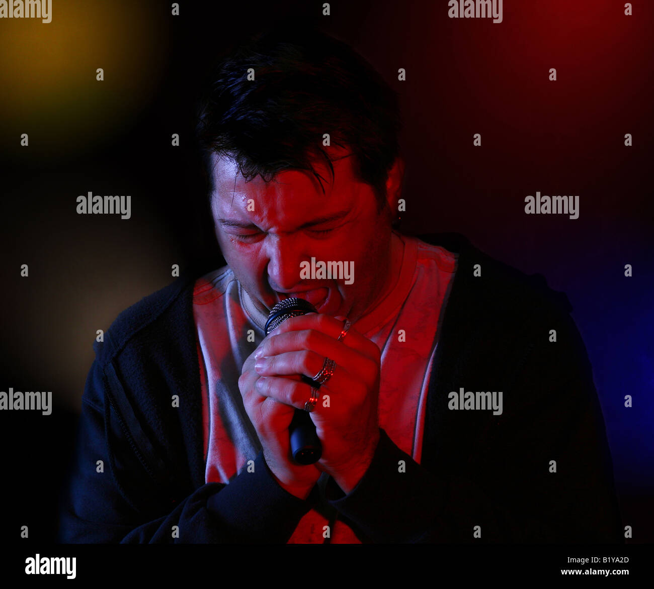 Rock singer on a scene singing rock in ecstasy Stock Photo - Alamy