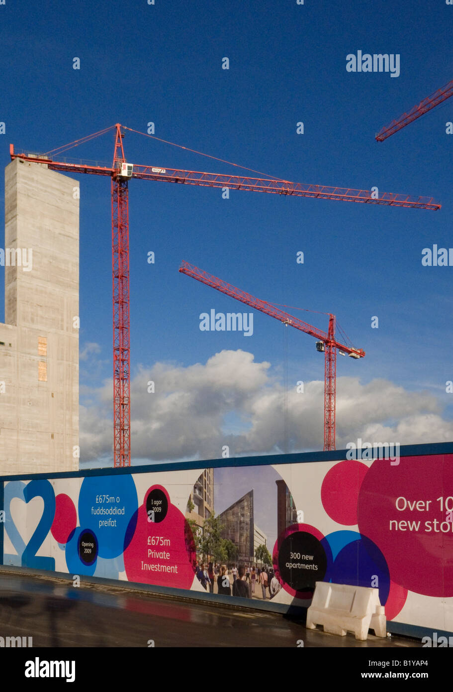 city centre building constrction showing hoarding red tower cranes blue ...
