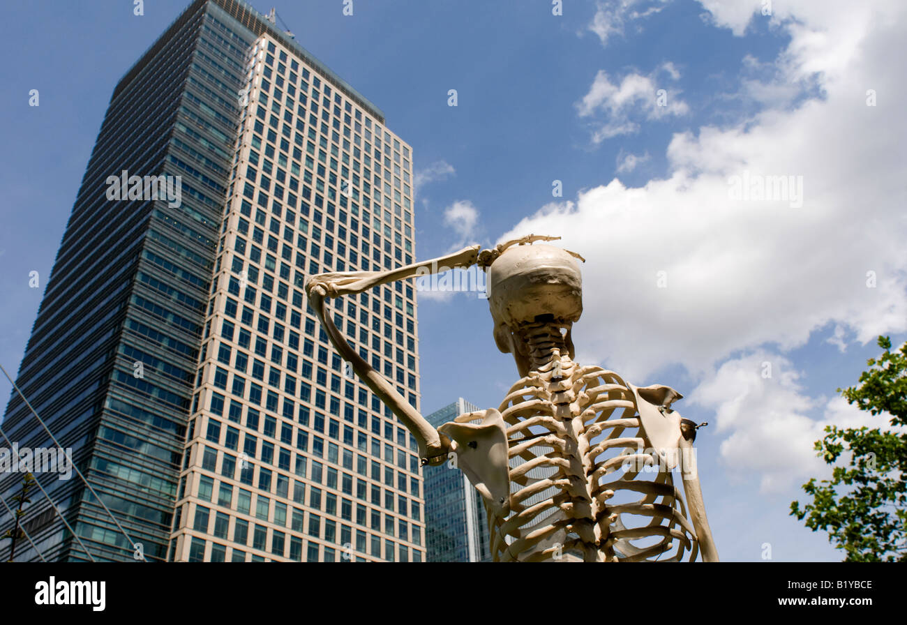 Human skeleton looking up at high rise office block, Canary Wharf ...