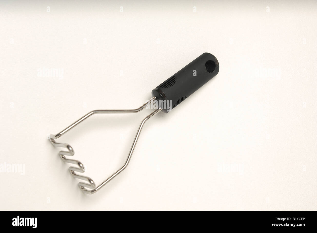 kitchen potato masher utensil Stock Photo - Alamy