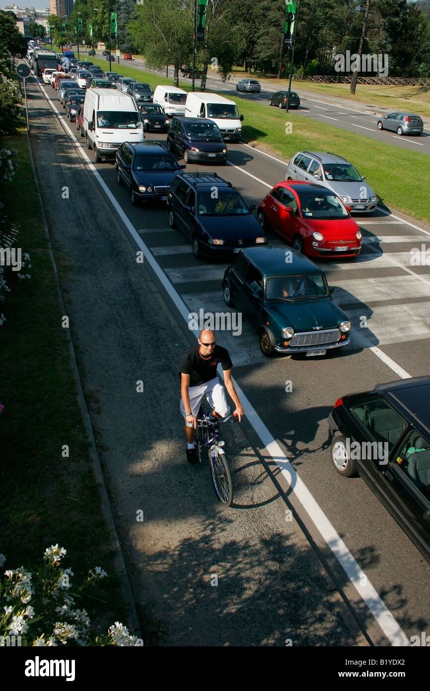 Cyclist riding his bike on a cyclepath next to the traffic cars in ...