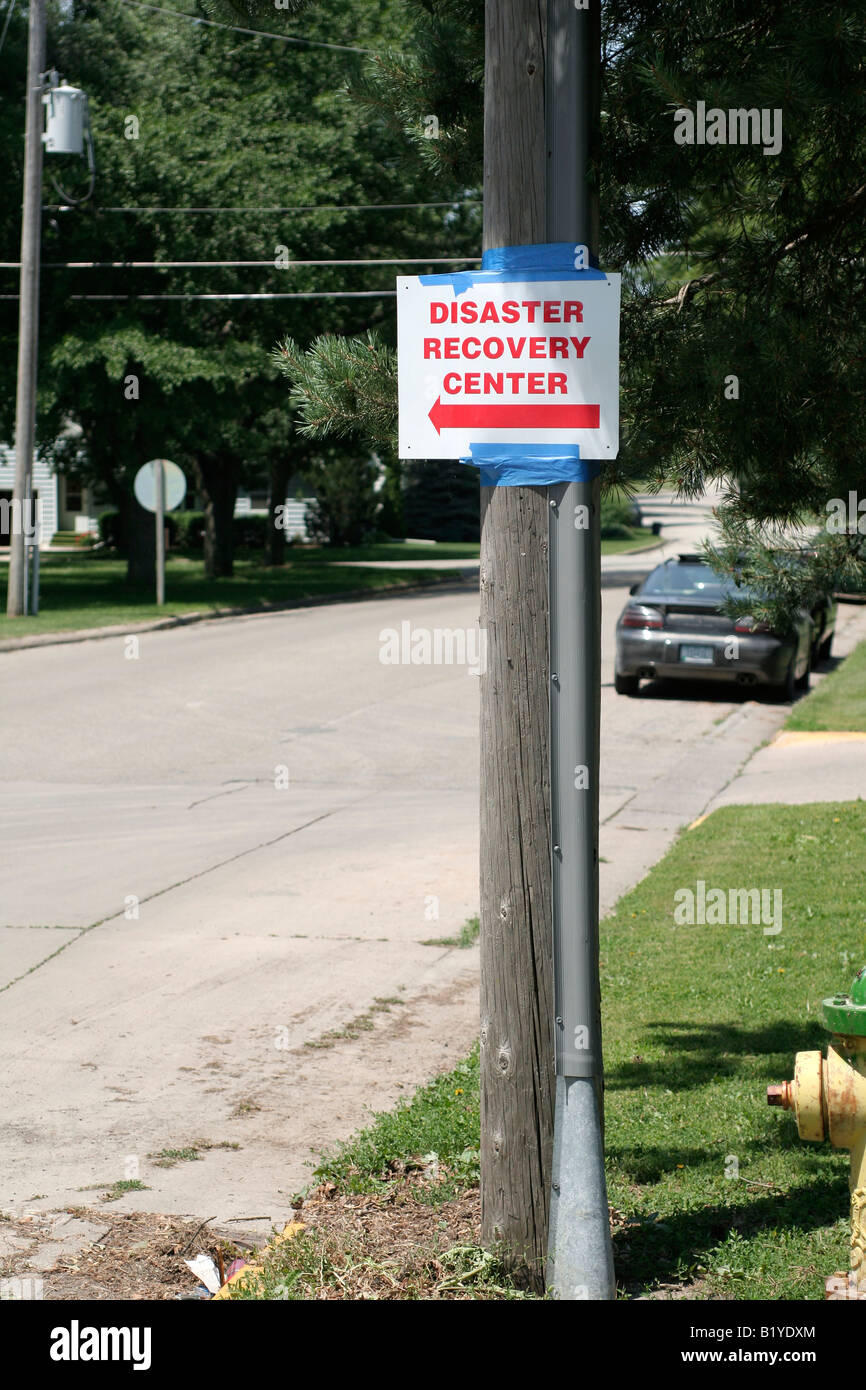 Sign in flooded out town pointing way to help Stock Photo - Alamy